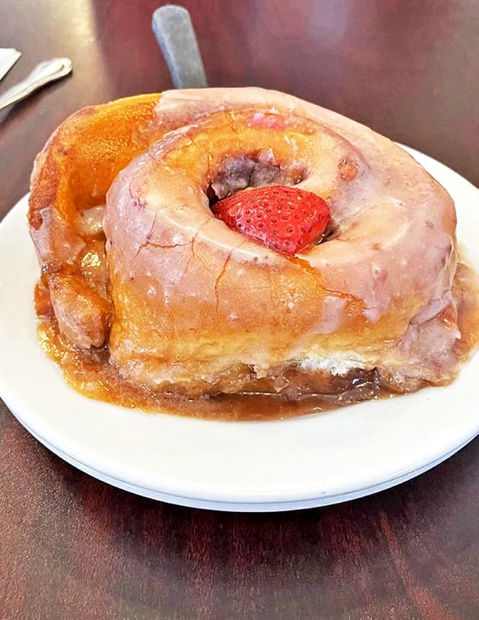 Triple Berry Cinnamon Roll: A strawberry sentinel guards the center of this berry-infused creation, where fruit and cinnamon dance in perfect harmony.