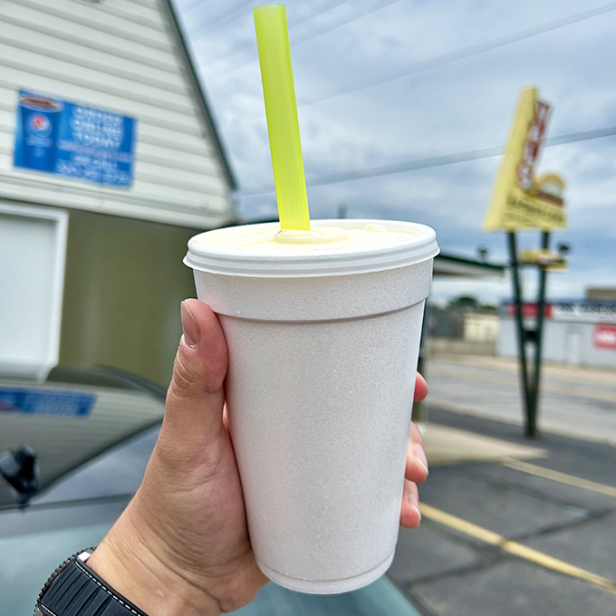 A frosty shake awaits its lucky recipient, the straw standing at attention in a sea of creamy goodness.