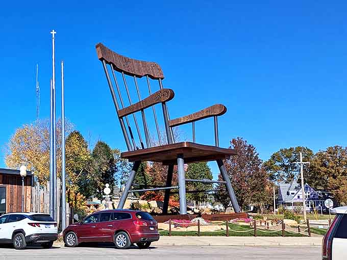 The landscaped setting frames the chair beautifully, with flowers and greenery softening the impact of all that massive wood and metal.