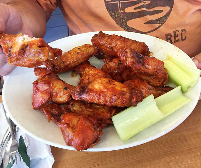 Wings that have clearly graduated from the school of serious smoke, glistening with sauce and flanked by cooling celery stalks.