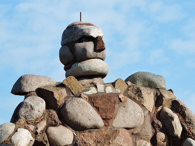 The intricate stonework reveals itself upon closer inspection &ndash; each rock precisely placed to create human-like features and proportions.