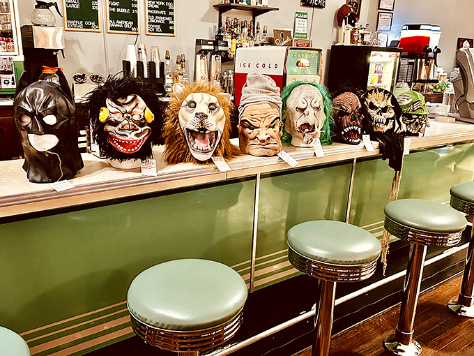 The soda fountain counter's quirky guardians &ndash; a collection of Halloween masks watching over patrons as they enjoy old-fashioned malts and phosphates.