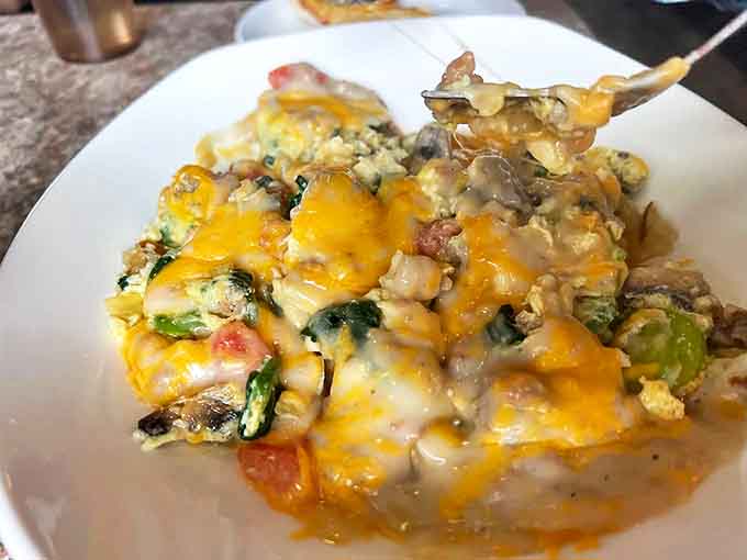 A colorful medley of vegetables, eggs, and cheese that might actually convince you to eat your greens before noon. Comfort food with nutritional alibis.