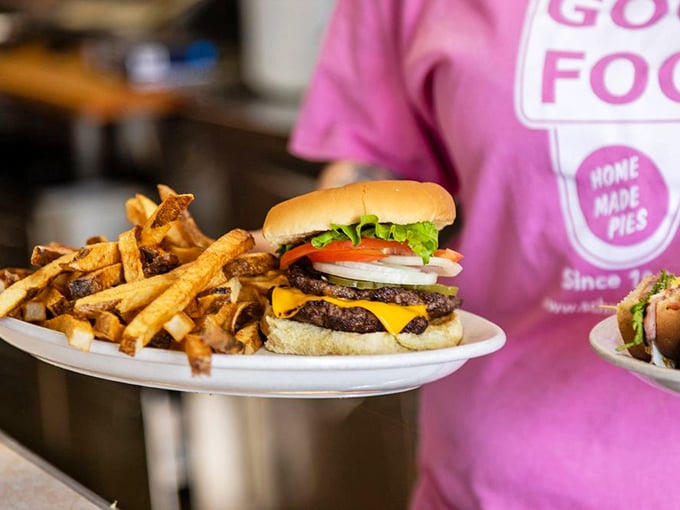 Burger and fries: The classic American duo arrives on a pristine white plate – a double-patty masterpiece with all the fixings alongside golden fries that demand to be savored.