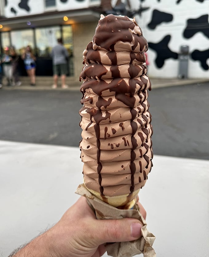 Chocolate lovers rejoice! This towering spiral of cocoa perfection drizzled with fudge sauce might require a building permit in some counties.