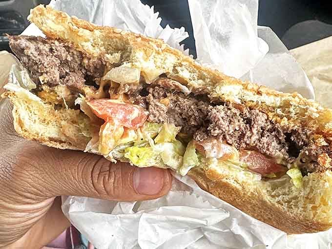 The cross-section reveals the truth: perfectly melded ingredients creating a harmonious burger symphony that justifies every calorie.