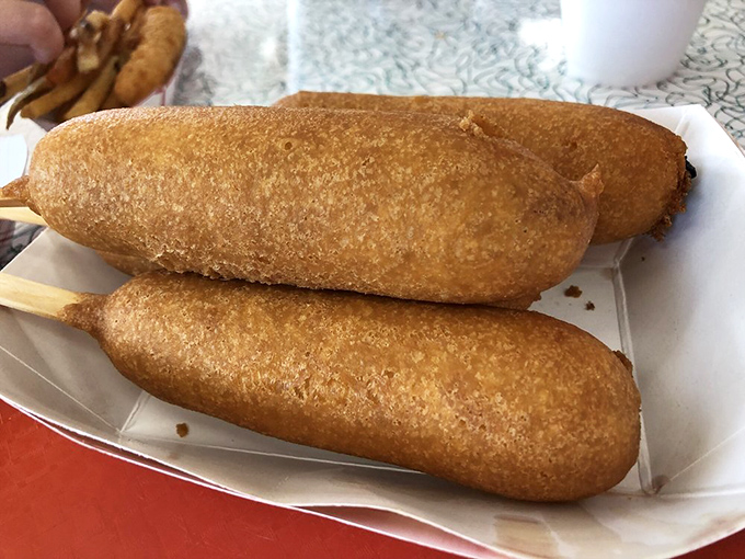 Three perfectly fried Cozy Dogs demonstrate the consistency that's kept travelers returning to this Springfield institution decade after decade.