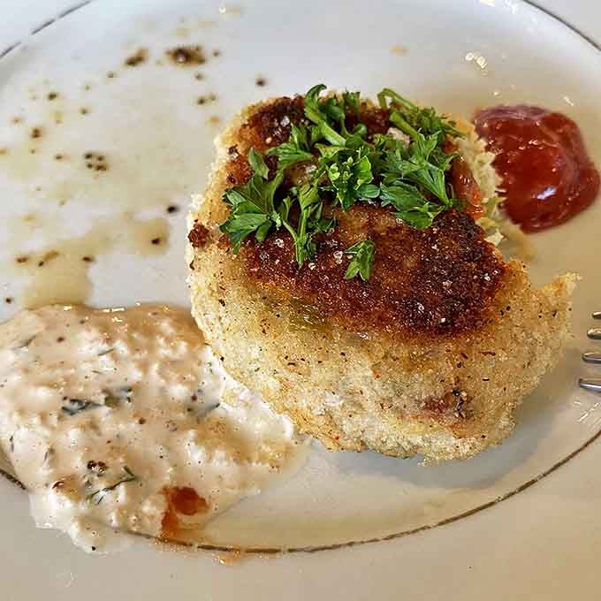 Close-up food romance: a perfectly seared crab cake with just enough remoulade to complement, not overwhelm, the star of the show.