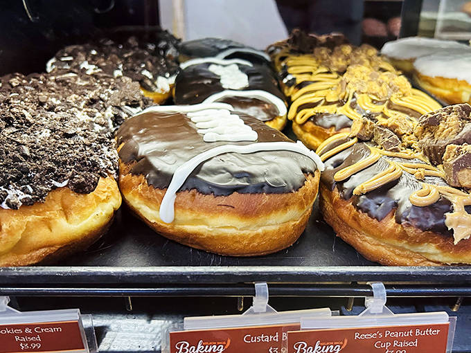 The bakery case showcases donuts that aren't just filled, they're practically bursting with creamy goodness waiting to ambush your shirt.