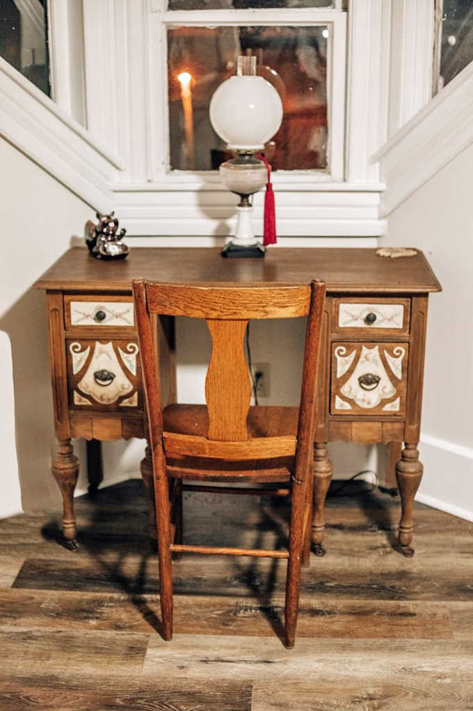 A writer's dream corner: This antique desk bathed in natural light practically begs for penning thoughtful letters or postcards home.
