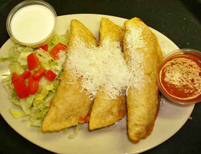 A complete flavor fiesta on one plate, these empanadas come flanked by fresh salsa and a sprinkle of cheese.
