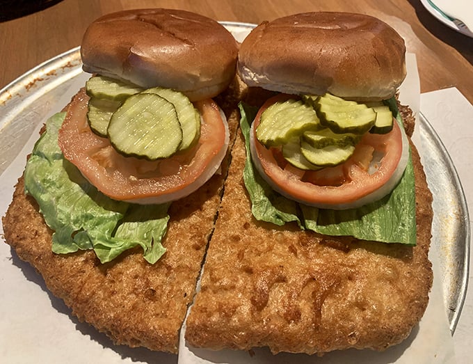 The King Tenderloin lives up to its royal name, with fresh toppings adding color to this golden-fried masterpiece of pork perfection.