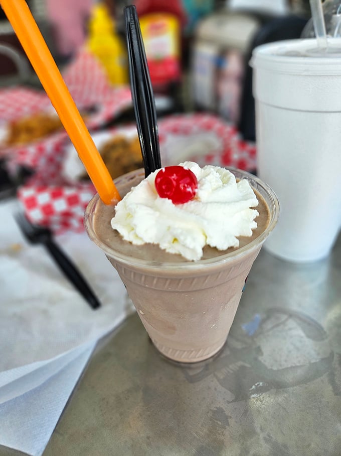 Thick enough to require both straw and spoon, this milkshake stands at attention, crowned with whipped cream and that obligatory cherry on top.