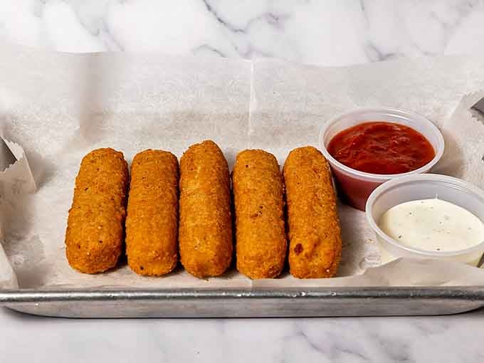 These mozzarella sticks have that perfect golden coating that promises melted cheese heaven with every bite.