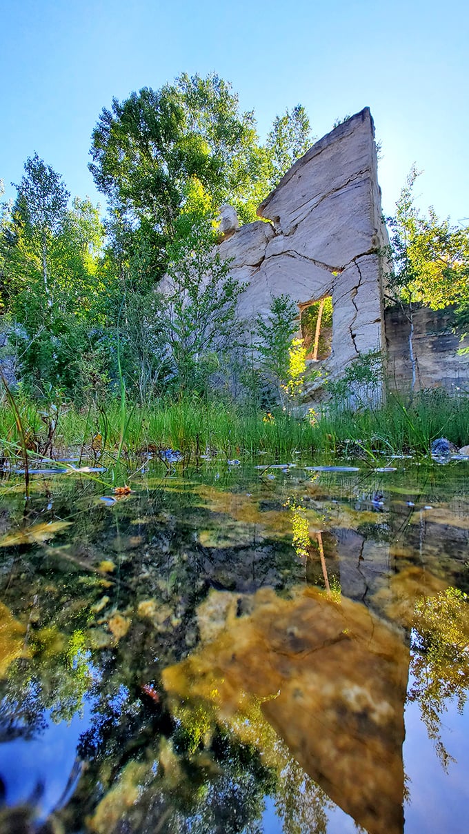 Mirror, mirror: Crystal-clear waters collect in the quarry's deeper sections, creating perfect reflections of the reclaimed industrial ruins.