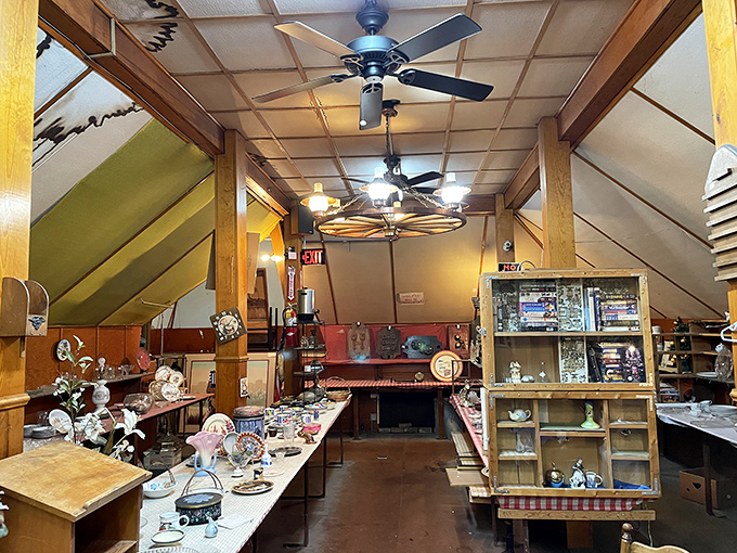 Wooden beams frame this attic-like space where vintage lamps cast a warm glow over collections that range from practical to whimsical.