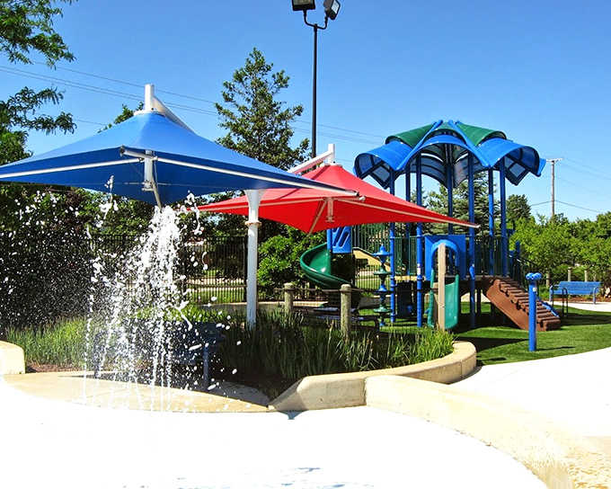 Rainbow-hued shade structures provide stylish sun protection while adding pops of color that make this splash pad area Instagram-worthy.