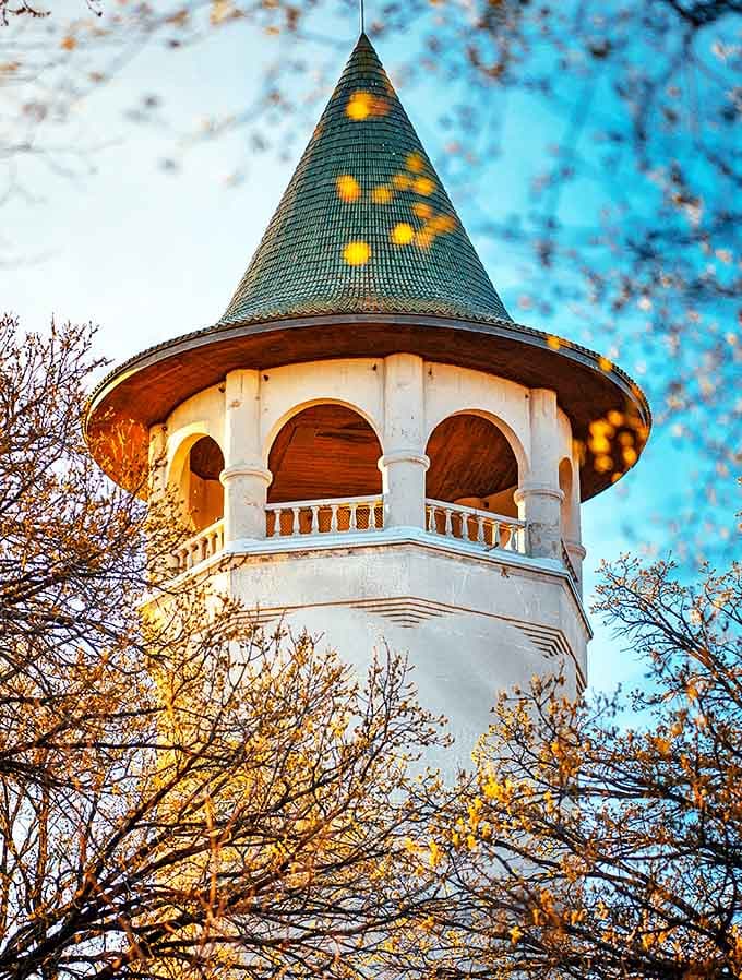 Golden hour transforms the tower's observation deck into a crown jewel, with sunlight dancing across its distinctive green roof.
