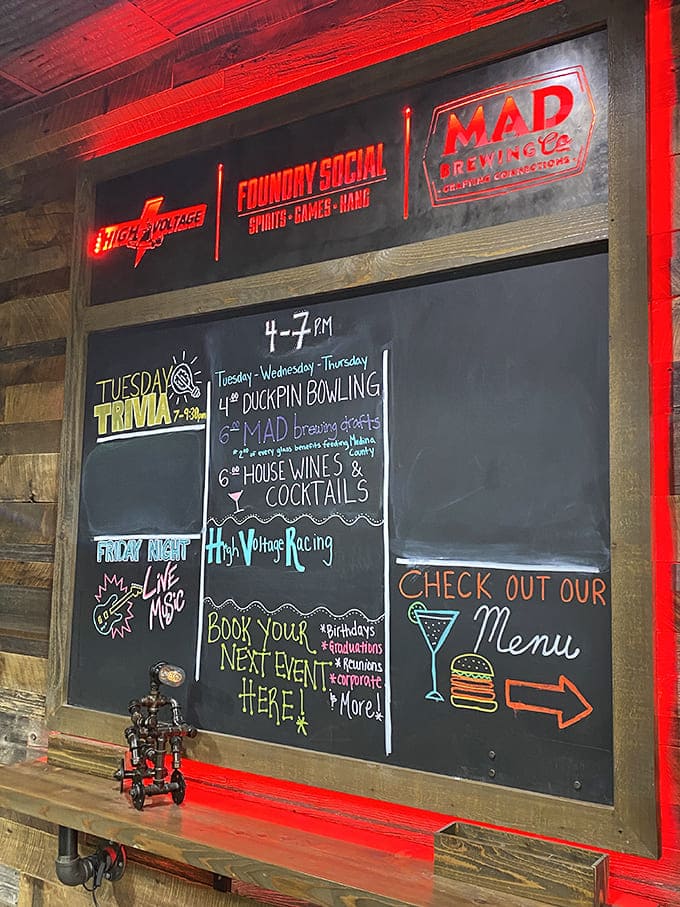 The chalkboard menu of weekly events proves High Voltage isn't just about racing &ndash; it's a community hub disguised as a speed palace.