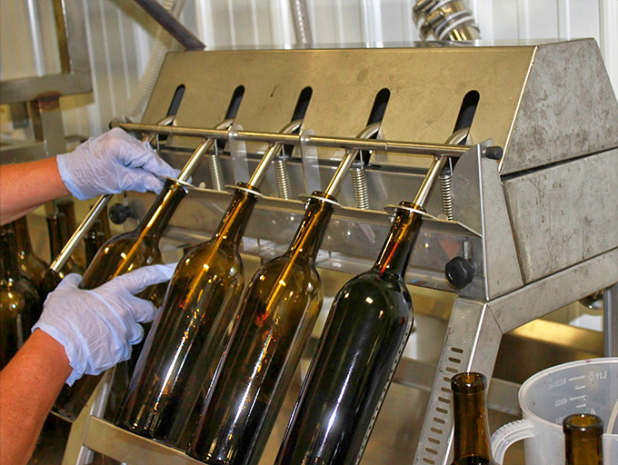 Where the magic happens &ndash; careful hands guide each bottle through the filling process, a blend of precision and passion.