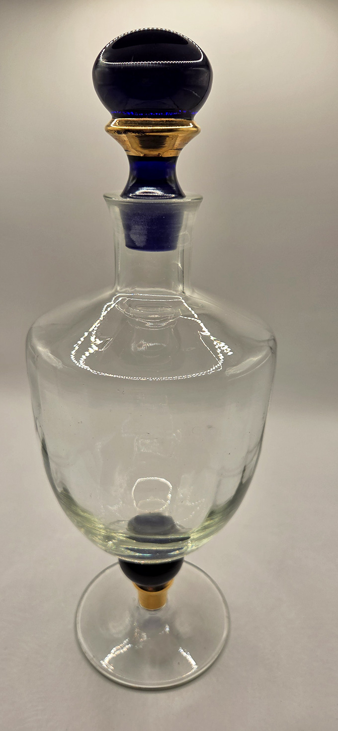 This elegant cobalt-topped decanter isn't just glassware &ndash; it's a portal to cocktail parties of yesteryear, when drinks were poured with ceremony and conversations lingered.