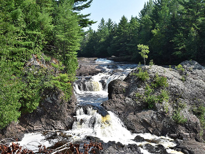 The rocky streambed at Potato Falls creates mini-rapids and pools, perfect for careful exploration on hot summer afternoons.