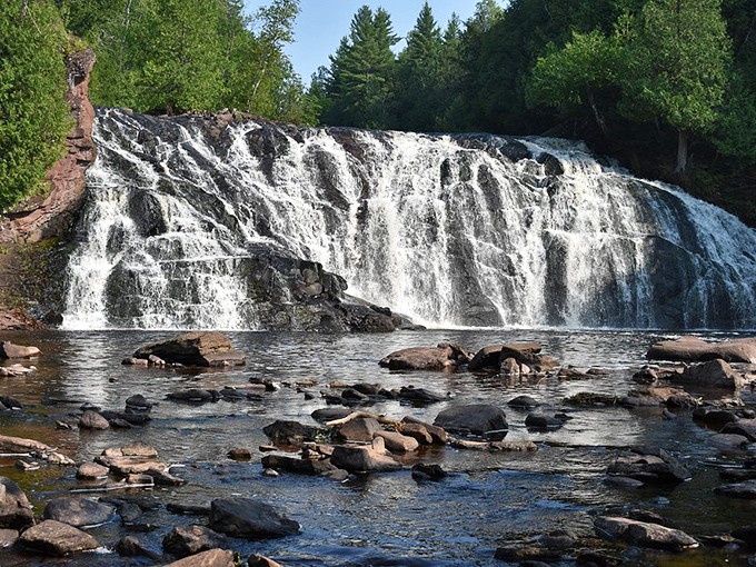 Potato Falls' upper section creates a powerful straight plunge that thunders into the pool below, sending mist swirling through sunbeams.