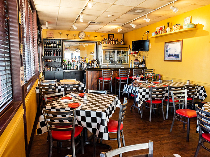 Checkered tablecloths and warm yellow walls create a cozy atmosphere inside TV's Deli & Diner, perfect for lingering over coffee.