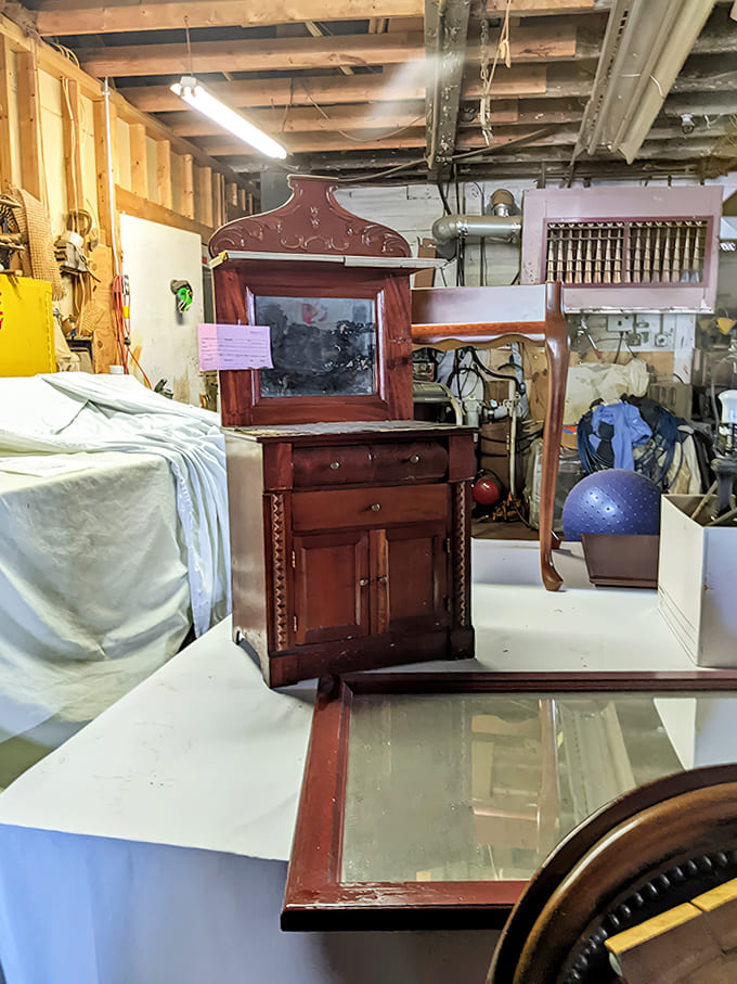 In the restoration workshop, furniture awaits its second act – this mahogany piece will soon grace someone's home with its rich patina and history.