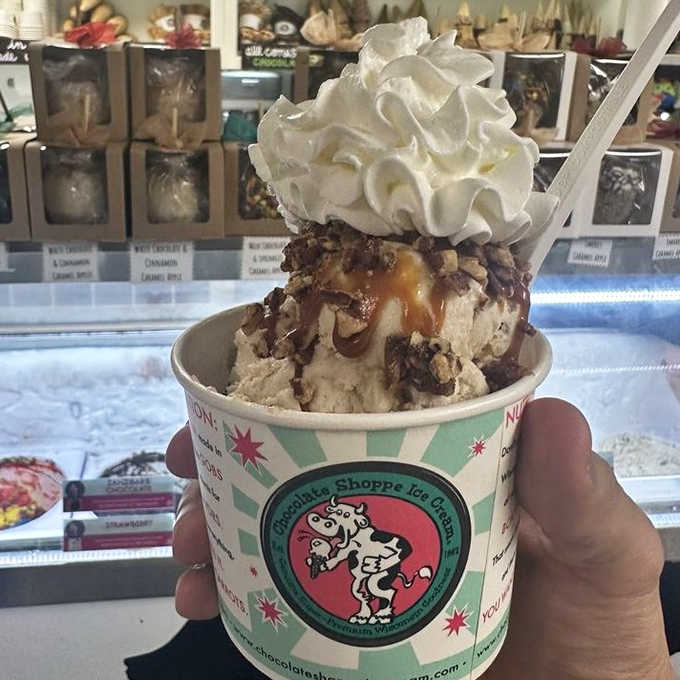 Ice cream architecture at its finest &ndash; a towering creation of creamy goodness topped with whipped cream that defies both gravity and restraint.