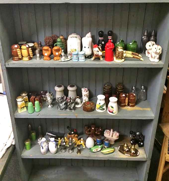 Salt and pepper shakers having a party on these shelves, proving that condiment containers used to have way more personality.