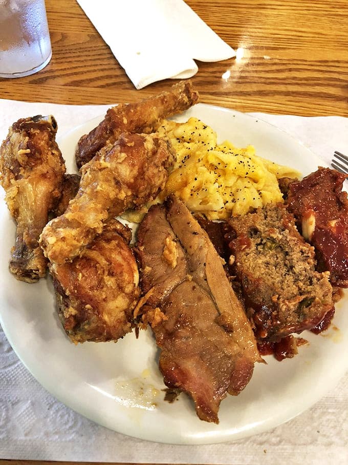 A plate loaded with crispy broasted chicken, tender roast beef, and creamy mac and cheese &ndash; the holy trinity of comfort food.