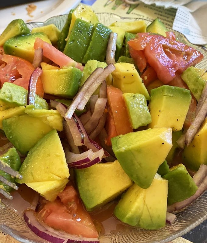 Chunky avocado cubes mingling with tomato and onion &ndash; a refreshing counterpoint to the heartier dishes.