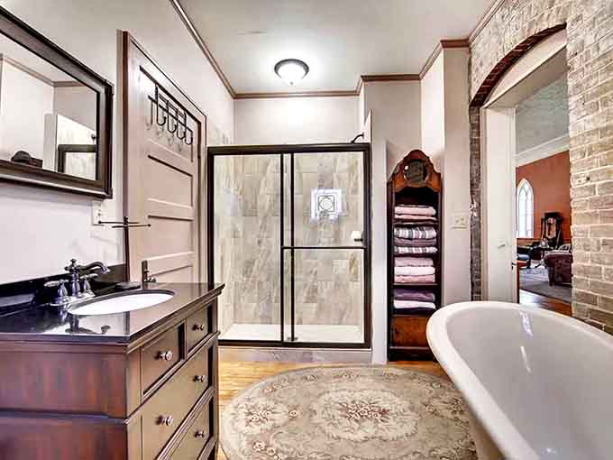 Soak your troubles away in this clawfoot tub where exposed brick and wooden floors create a baptism of relaxation.