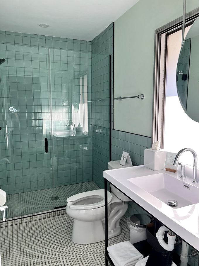 Mint-green tiles transform a standard bathroom into a refreshing oasis that channels vintage vibes with modern cleanliness.