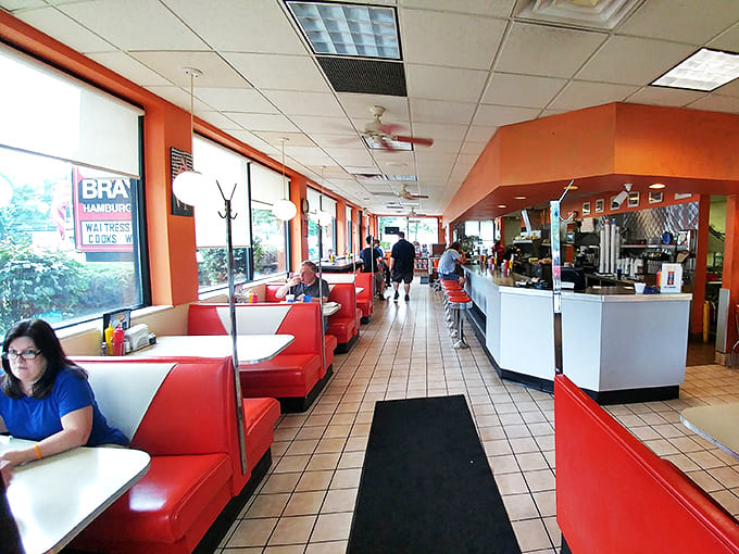 Red vinyl booths line the windows, offering front-row seats to the burger theater where every meal feels like a special occasion.