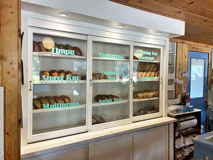 The bread case – where loaves of limpa, sourdough, and multigrain stand at attention, crusts gleaming like they're auditioning for a baking show.