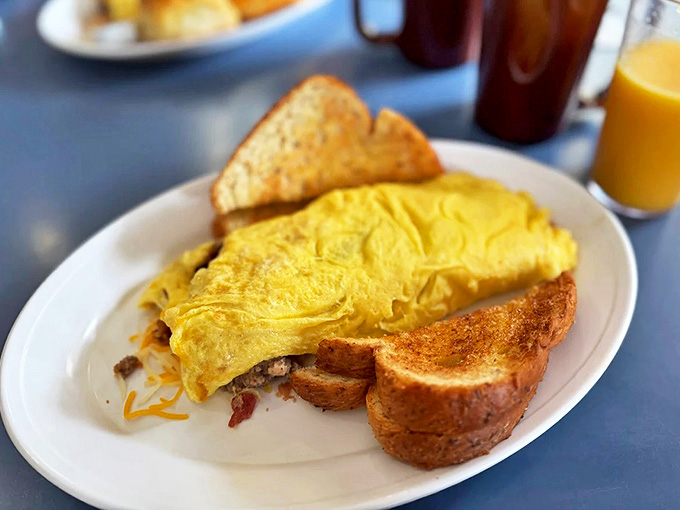 Fluffy eggs folded over savory fillings and served with perfectly toasted bread &ndash; morning comfort defined.