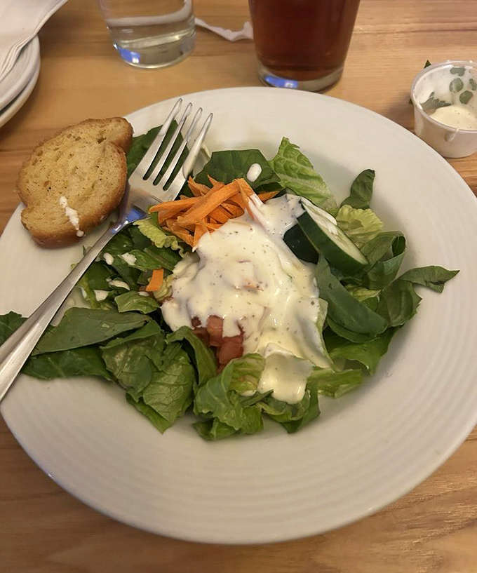 A fresh salad that doesn't feel like punishment &ndash; crisp greens, thoughtful toppings, and dressing that ties everything together in harmony.