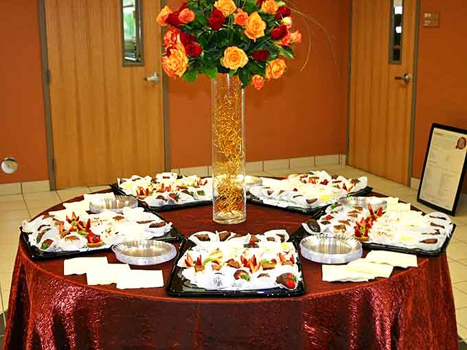 A floral centerpiece presides over platters of French delicacies – proof that even Florida parties can have a Parisian accent.
