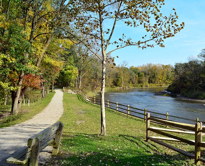 This riverside path invites contemplative strolls where the only decision is whether to sit on the next bench or keep wandering.