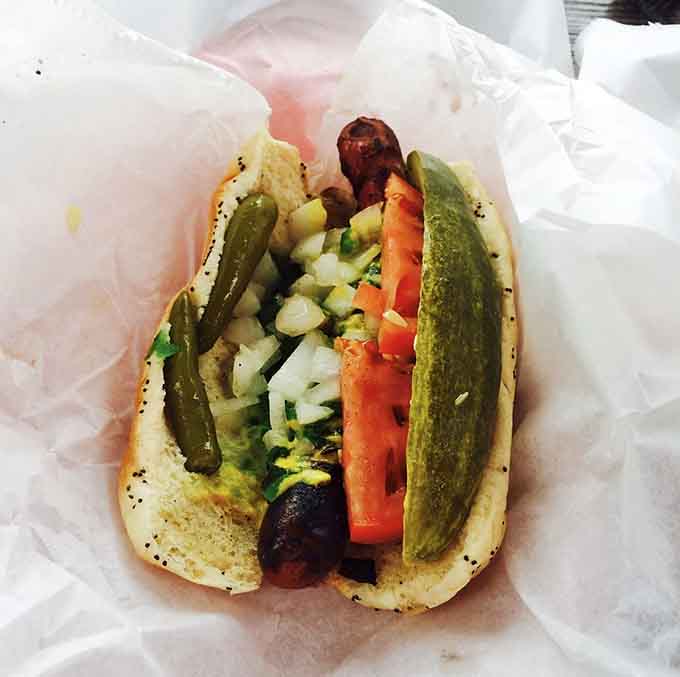 A Chicago-style hot dog dressed to the nines shows that Paradise Pup respects all forms of grilled greatness, not just burgers.