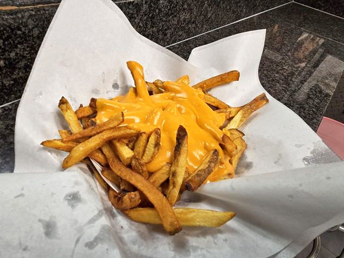Golden fries smothered in melted cheddar cheese &ndash; a decadent side that often becomes the main event for devoted cheese fry enthusiasts.
