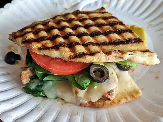 This grilled panini isn't just lunch&mdash;it's architecture on a plate, with perfect grill marks containing layers of melty cheese and fresh veggies.