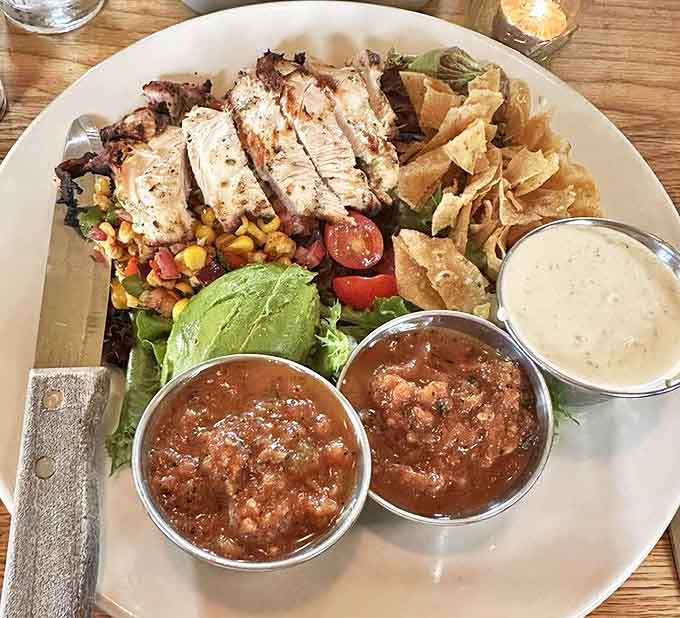 A salad that doesn't feel like punishment. Grilled chicken, fresh vegetables, and those little metal cups of salsa that say, "We care about presentation."