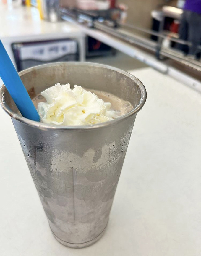 Chocolate Milkshake: Served in a frosty metal cup with that signature blue straw &ndash; thick enough to require patience but worth every delicious effort.