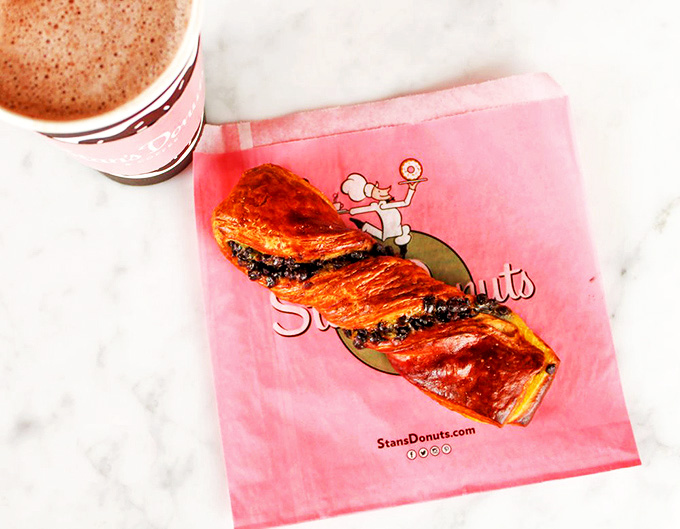 A chocolate twist donut with vanilla drizzle that's dressed better than most people at fashion week &ndash; elegant, indulgent, and unapologetically decadent.