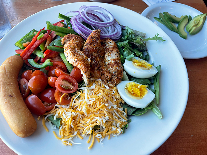A Cobb salad that's fooling absolutely no one about being "healthy" &ndash; loaded with grilled chicken, bacon, eggs, and enough cheese to make Wisconsin proud.