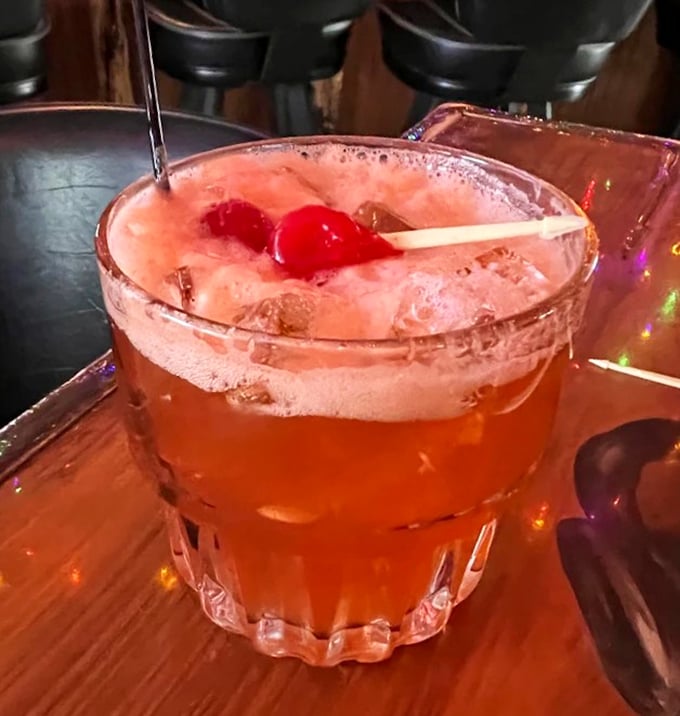 A cherry-topped cocktail at Little Brown Jug, foamy, vibrant, and mixed with classic Wisconsin charm.