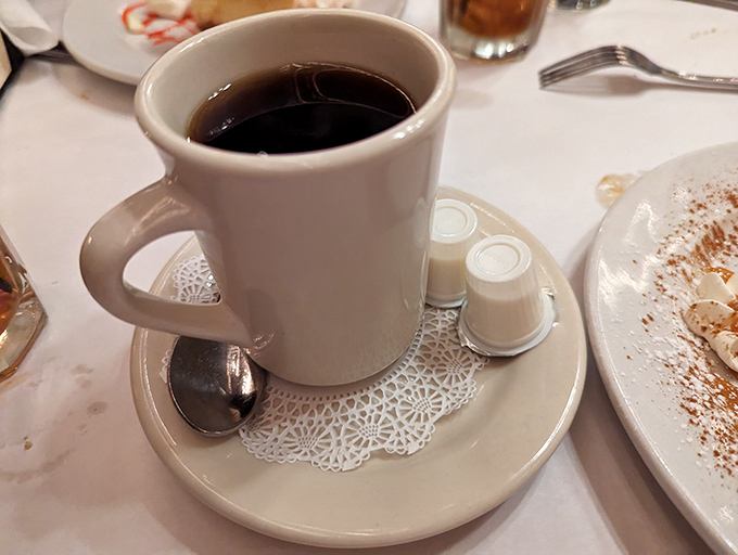 There's something wonderfully nostalgic about finishing your meal with a simple cup of coffee served on a delicate doily.